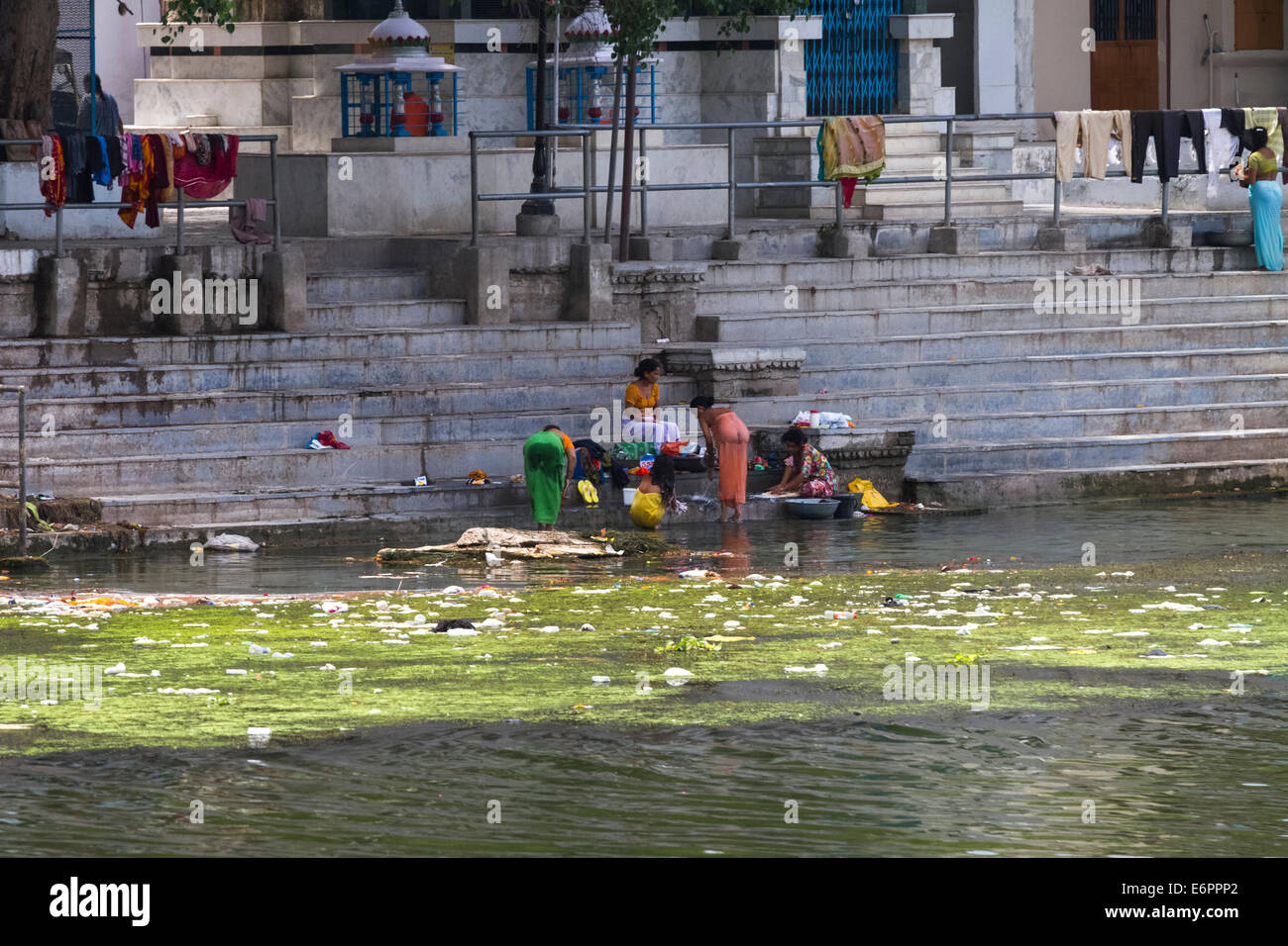 Indian women bathing and washing clothes on the banks of Lake Pichola ...