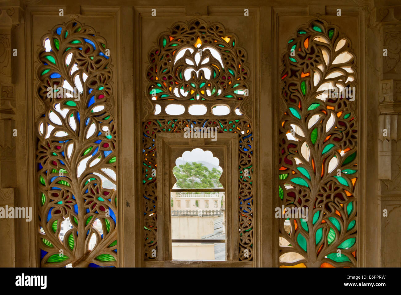 Multi-colored stained glass window with ornamental carvings inside City ...