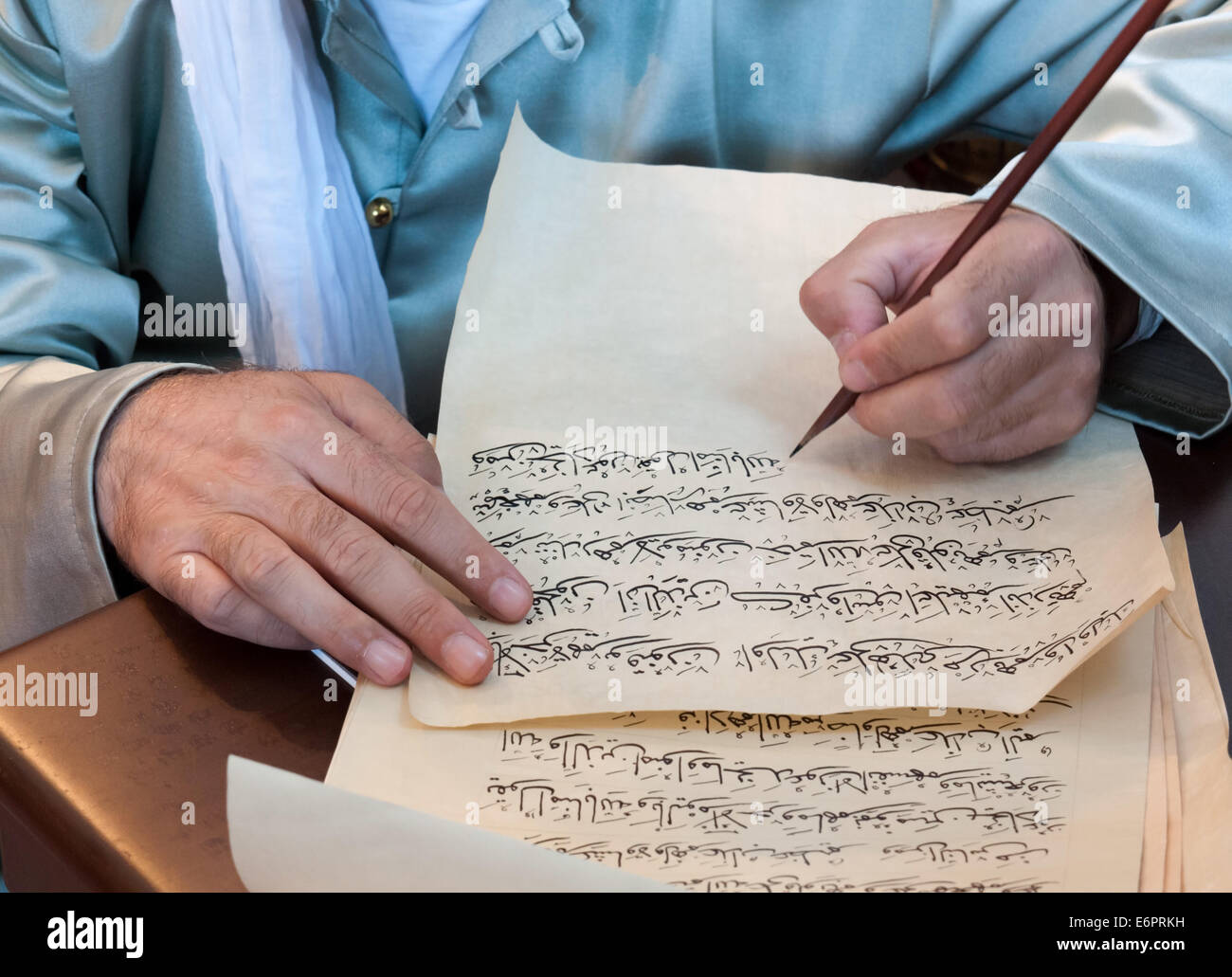 Male hands writing traditional Arabian calligraphy Stock Photo - Alamy