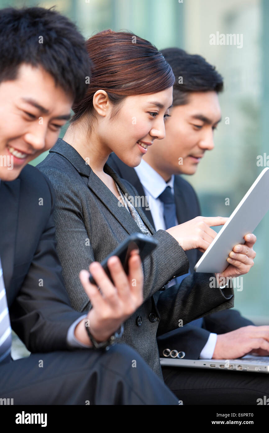 Business people using wireless technology Stock Photo - Alamy