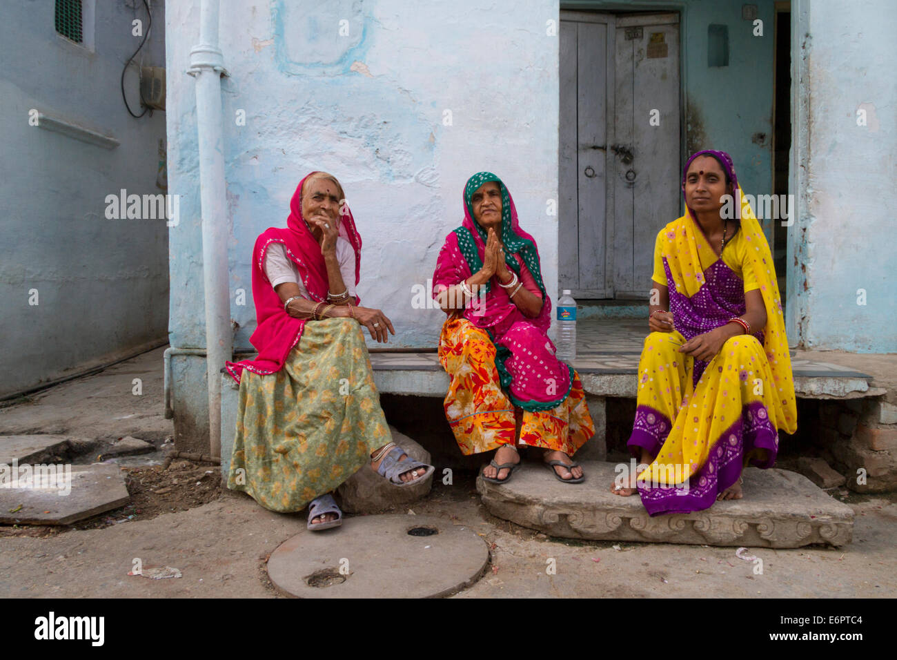 Group of local Indian women sitting on the steps of a house, chatting ...