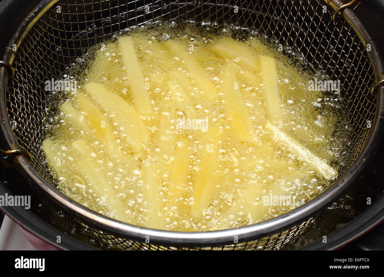 Heap of french fries fried in oil, deep fried Stock Photo - Alamy
