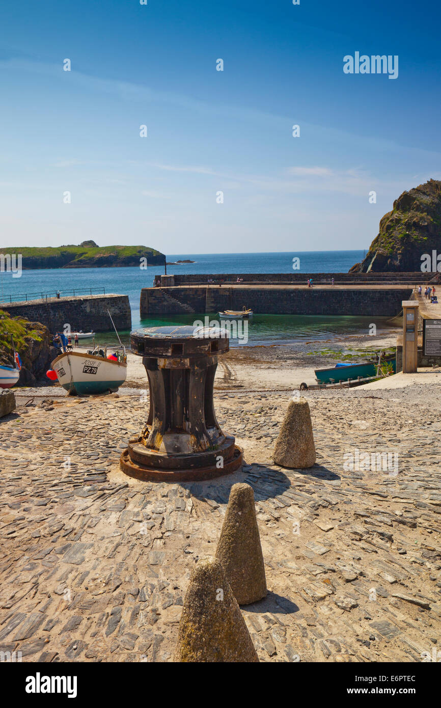 An historic wooden capstan in the picturesque harbour at Mullion Cove ...