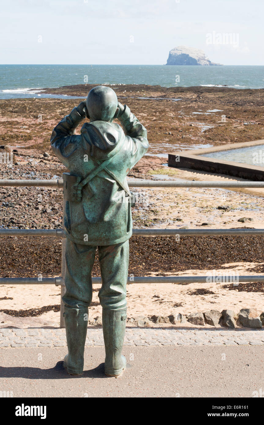 Bronze sculpture The Watcher by Kenny Hunter with Bass Rock in he ...