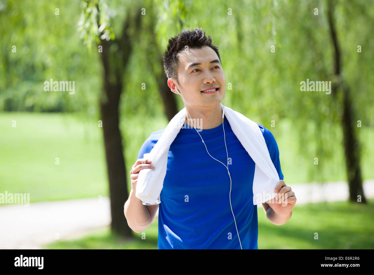 Young man jogging in the park Stock Photo - Alamy