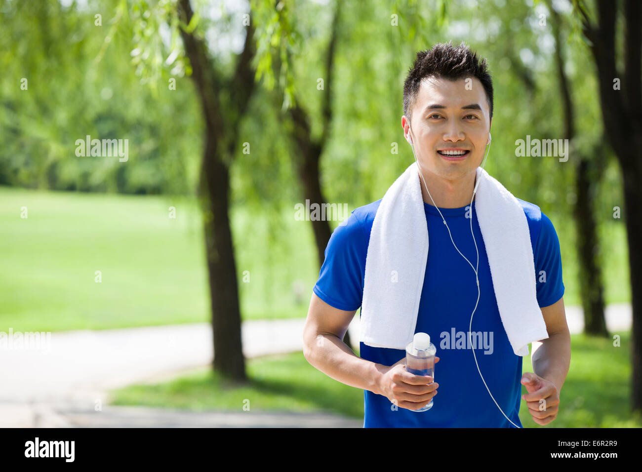 Young man jogging in the park Stock Photo - Alamy