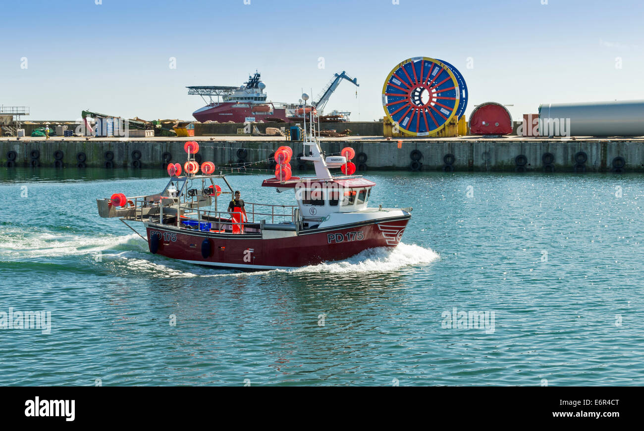 PETERHEAD HARBOUR ABERDEENSHIRE A SMALL FISHING BOAT LEAVING THE ...
