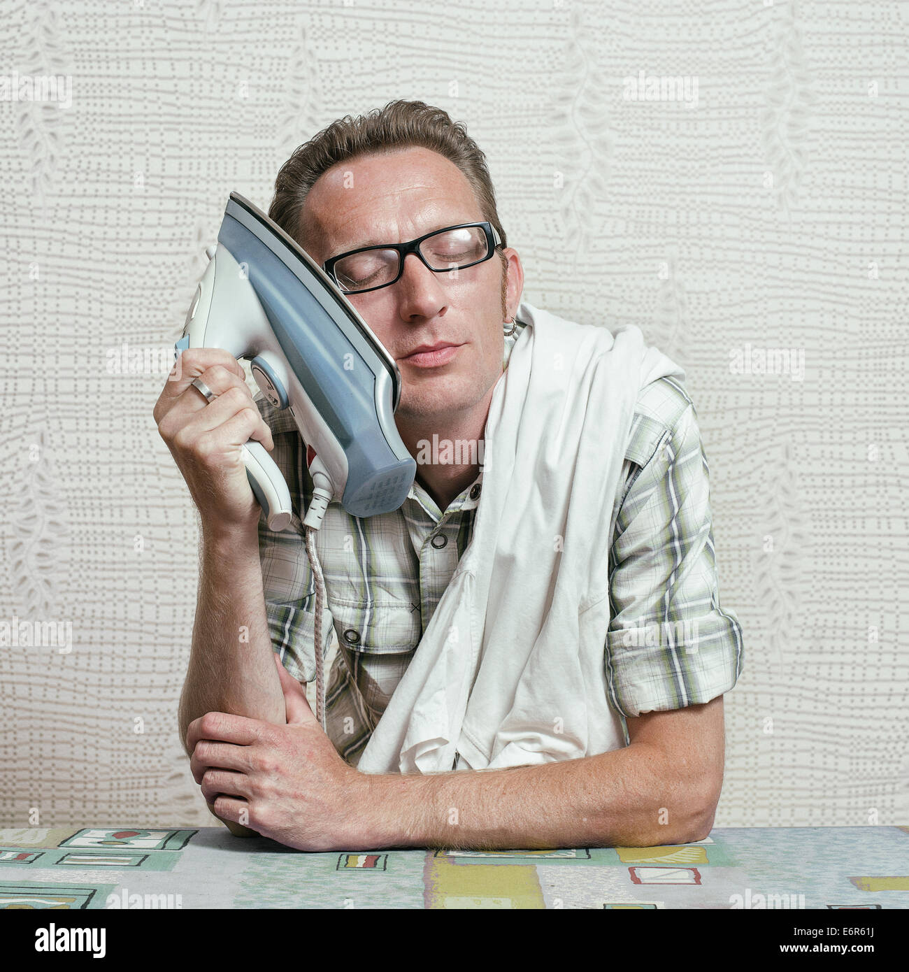 Tired man lean his cheek to iron and close eyes with happy smile Stock ...