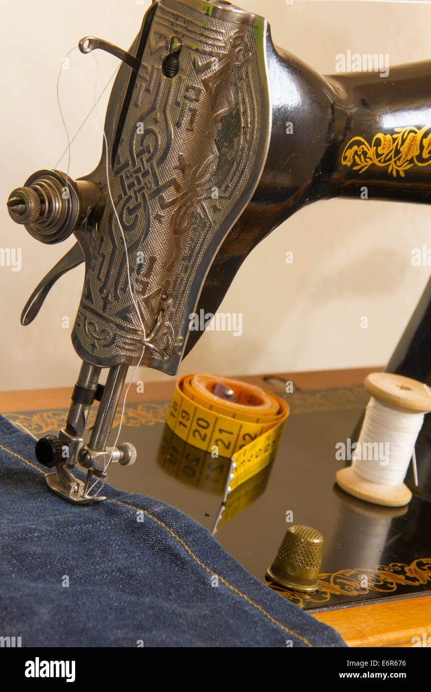 Sewing machine,measuring tape and item of clothing material Stock Photo ...