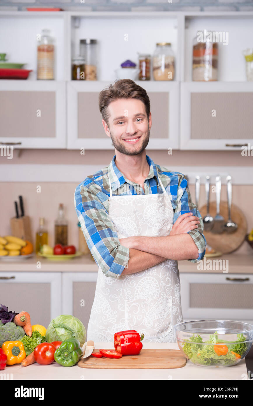 Smiling man cooking dinner in kitchen Stock Photo - Alamy