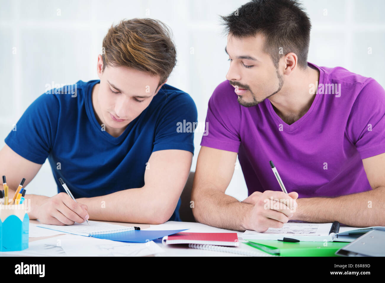 Students taking notes in classroom Stock Photo - Alamy