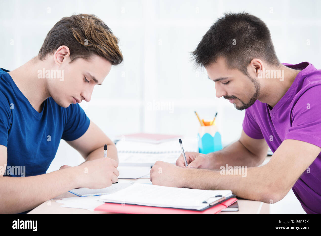 Students taking notes in classroom Stock Photo - Alamy
