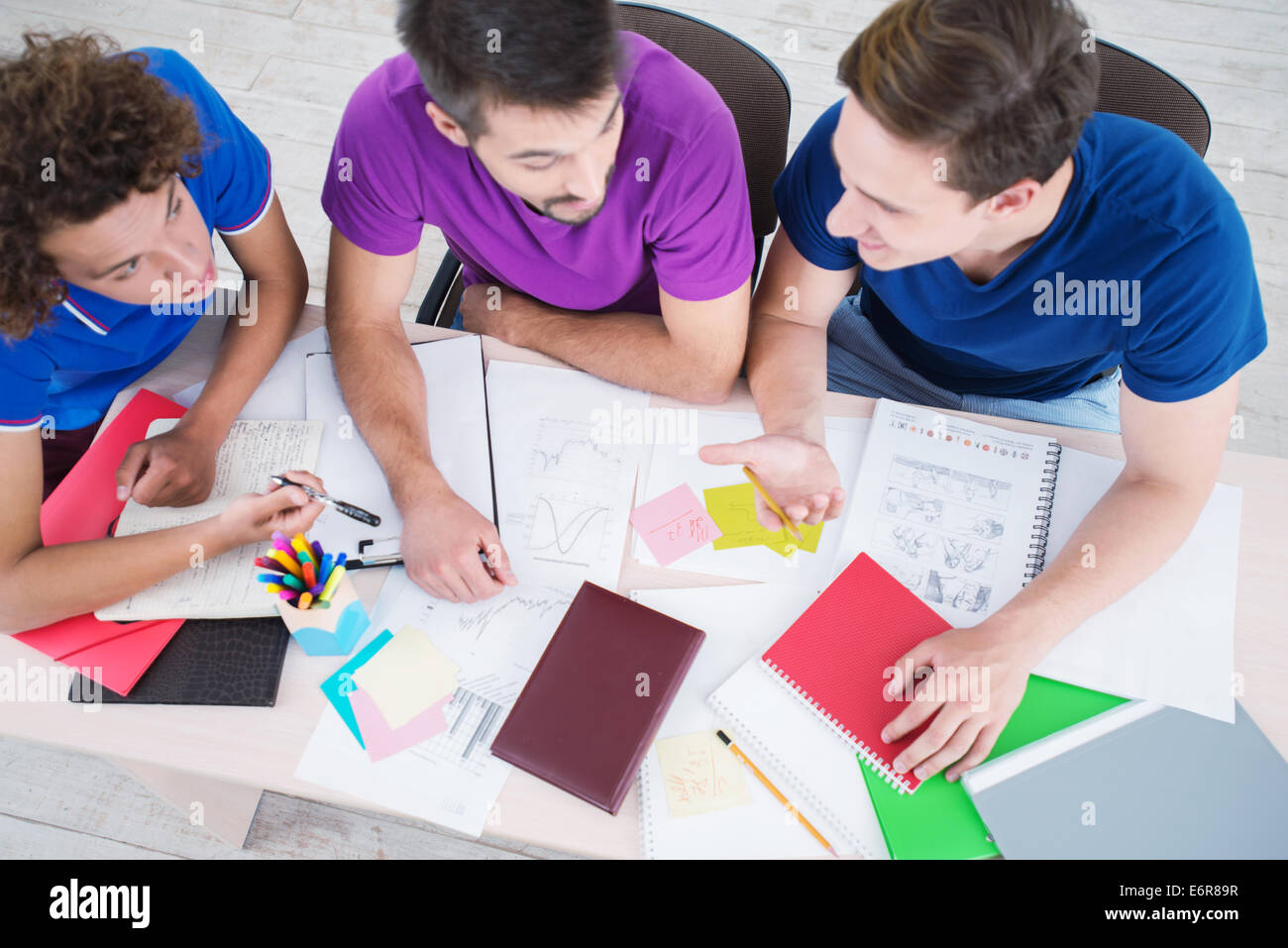Students discussing new information in classroom Stock Photo - Alamy