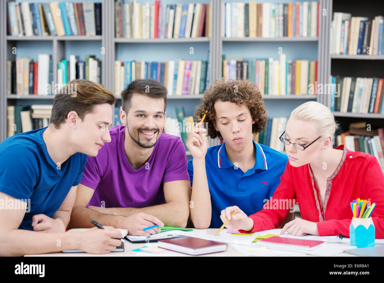Students discussing new information in classroom Stock Photo - Alamy