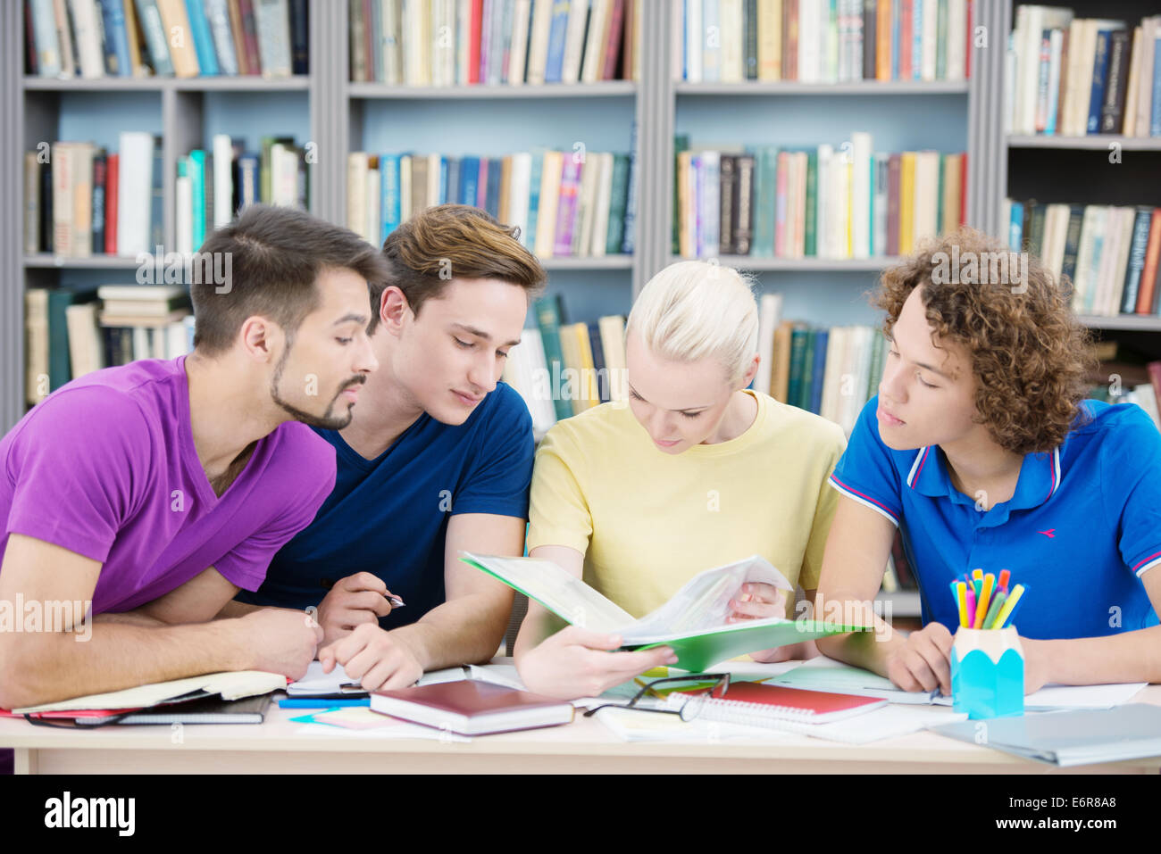 Students reading new information in classroom Stock Photo - Alamy