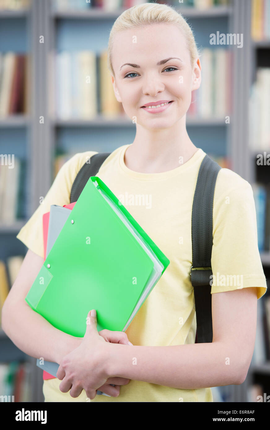Teenage student with folders Stock Photo - Alamy