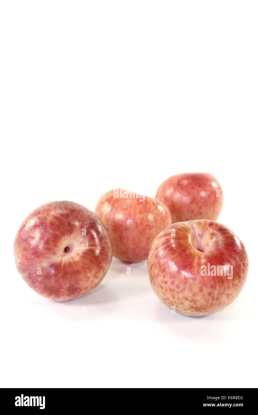 delicious orange-red pluots on a light background Stock Photo - Alamy