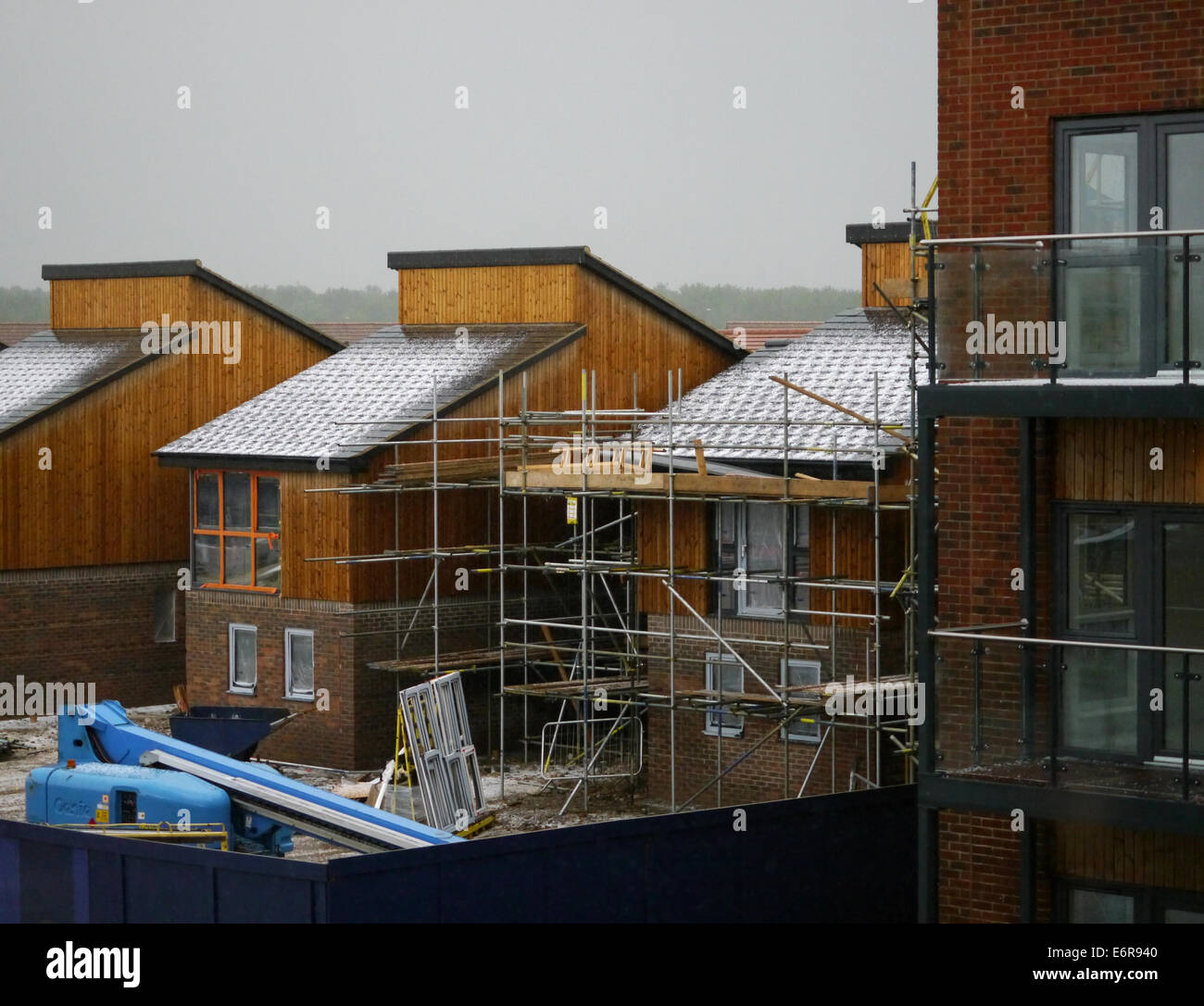 A residential building site showing two houses in mid construction with ...