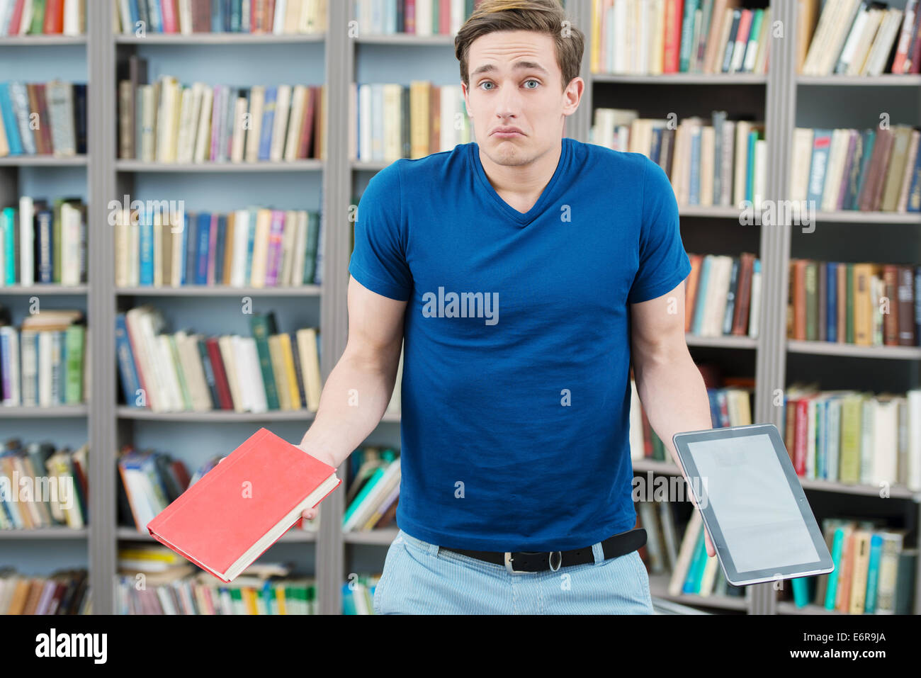 Confused student trying to choose between book and computer Stock Photo ... Confused student trying to choose between book and computer Stock Photo ...