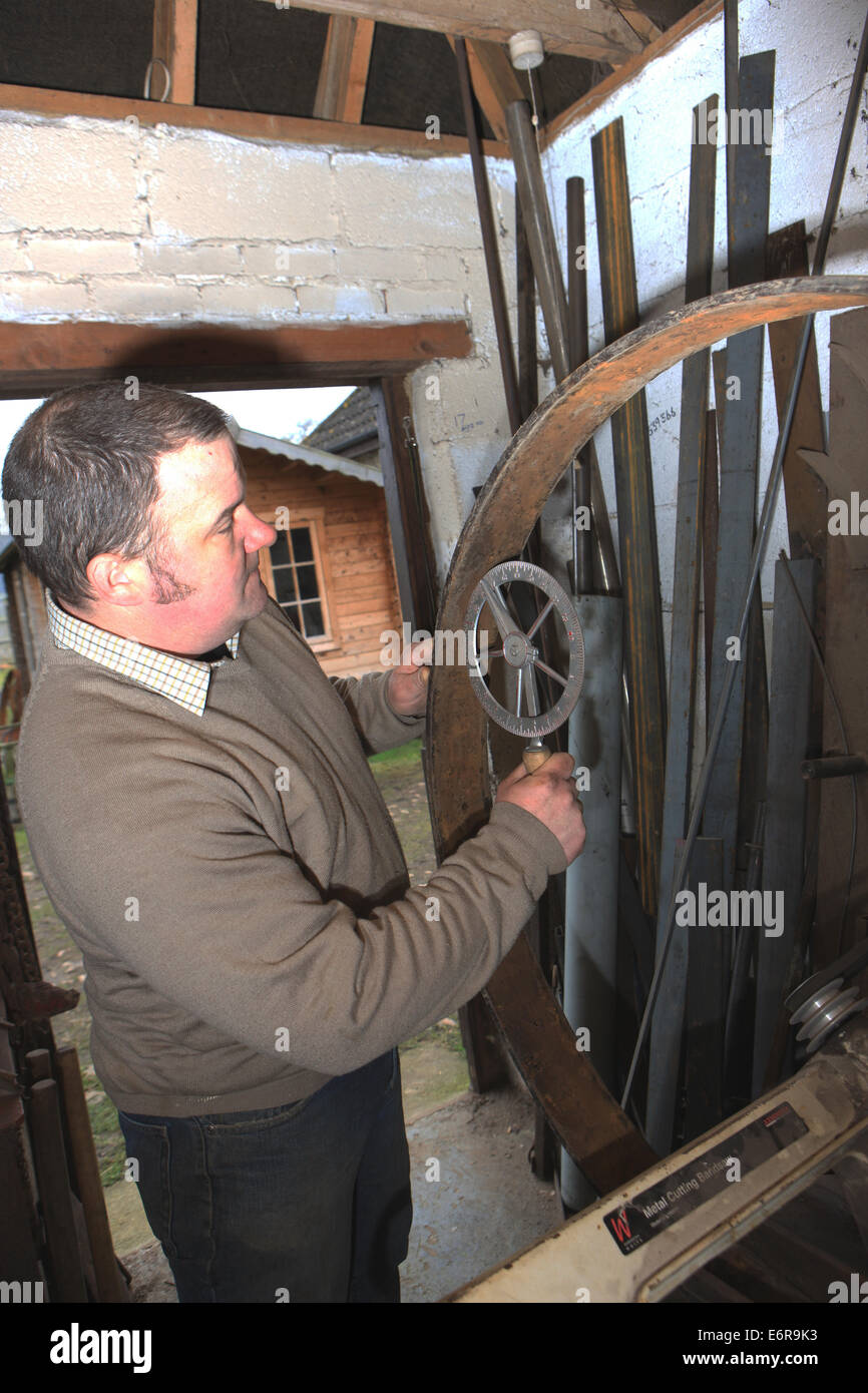 Traditional wheelwright Greg Rowlands working on a new wheel in his ...