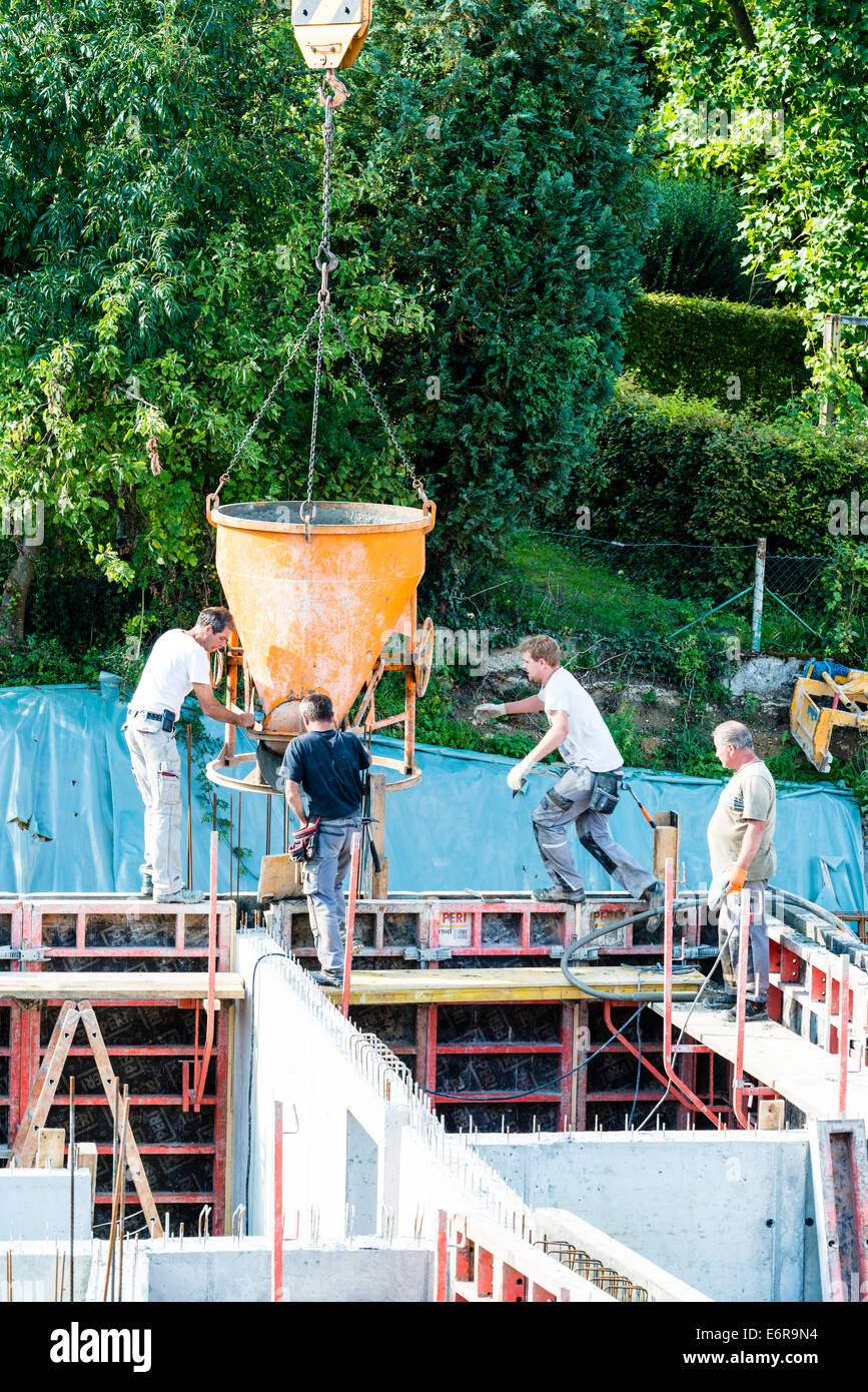 workers at construction site pouring concrete in form Stock Photo - Alamy