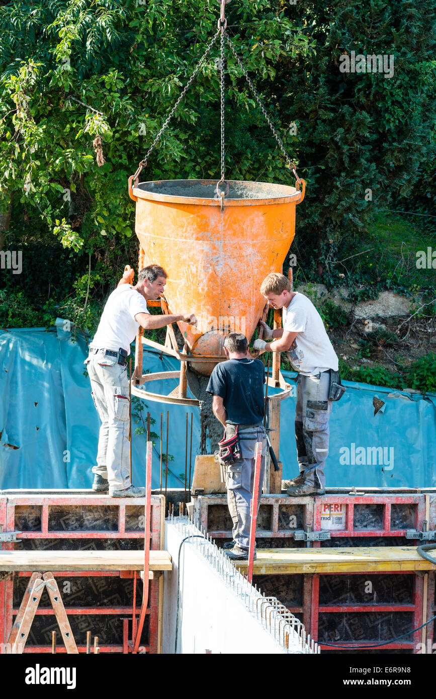 workers at construction site pouring concrete in form Stock Photo - Alamy