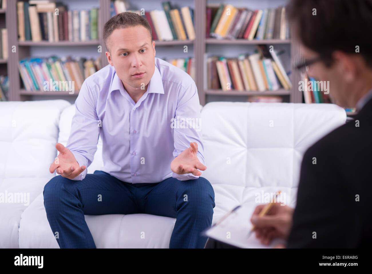 Man talking to his psychologist Stock Photo - Alamy