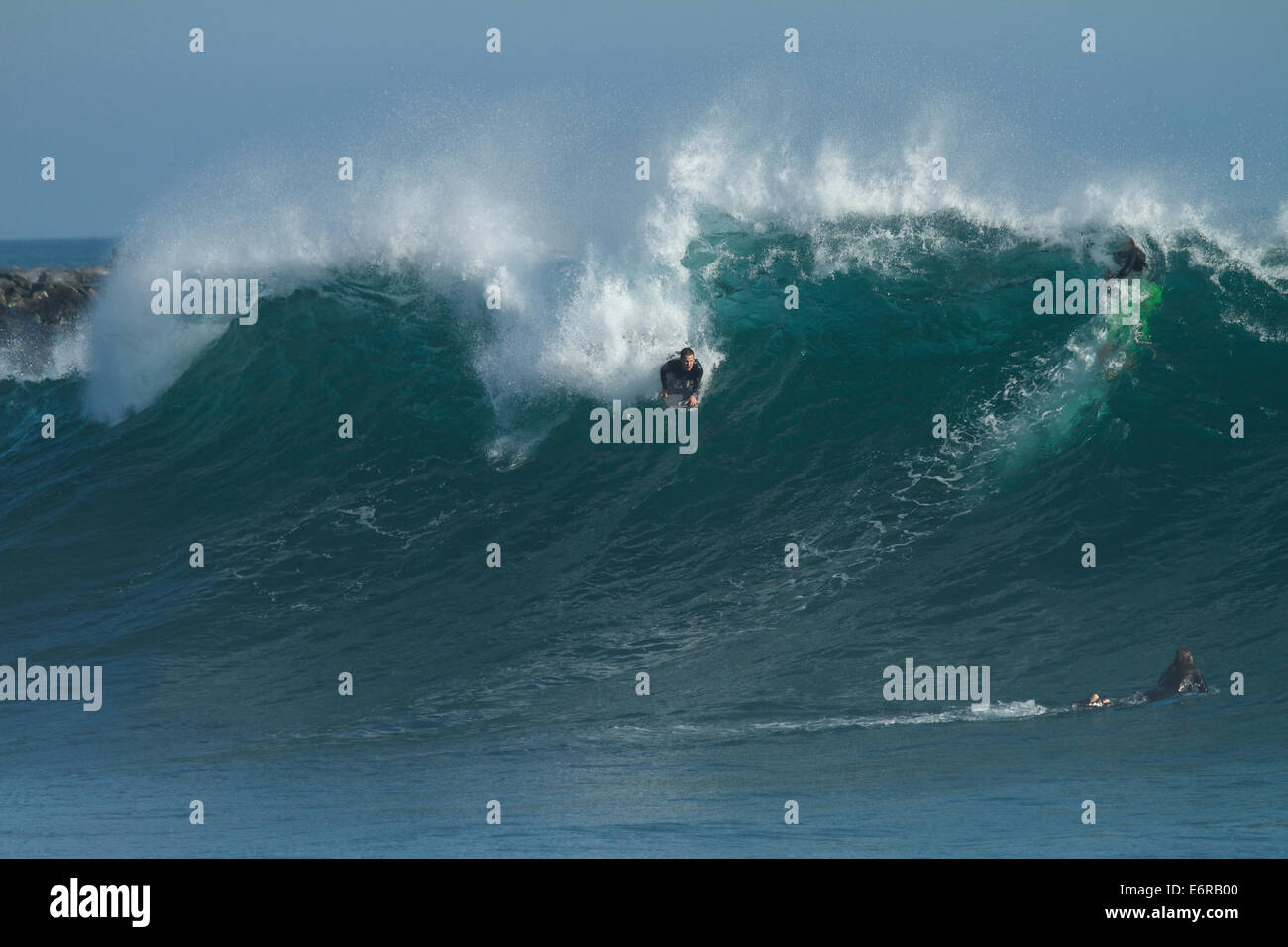 Surfers riding a bodyboard the huge surf created by Hurricane Marie in ...