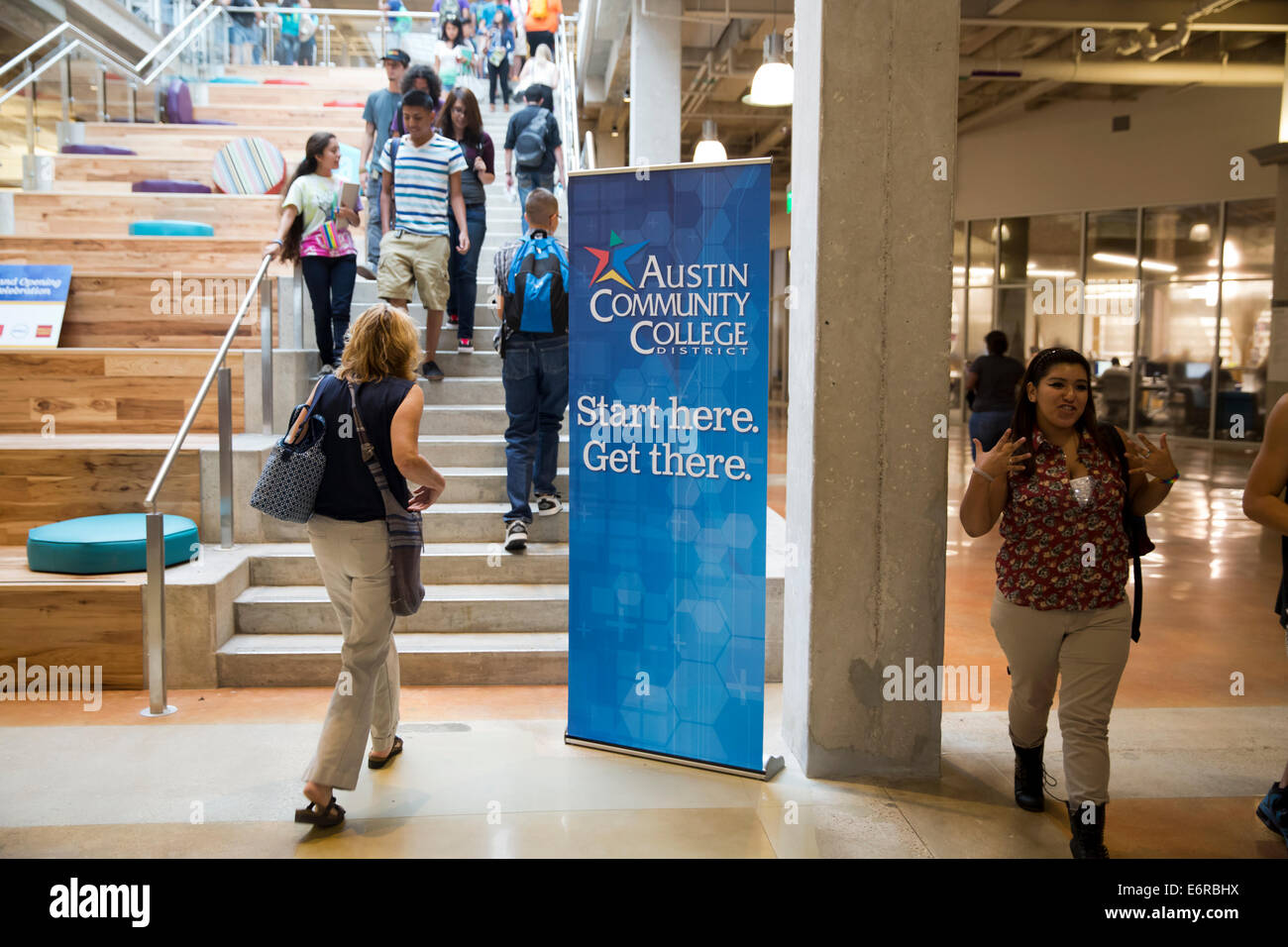 students of all ages and teachers walk up and down stairs during change ...