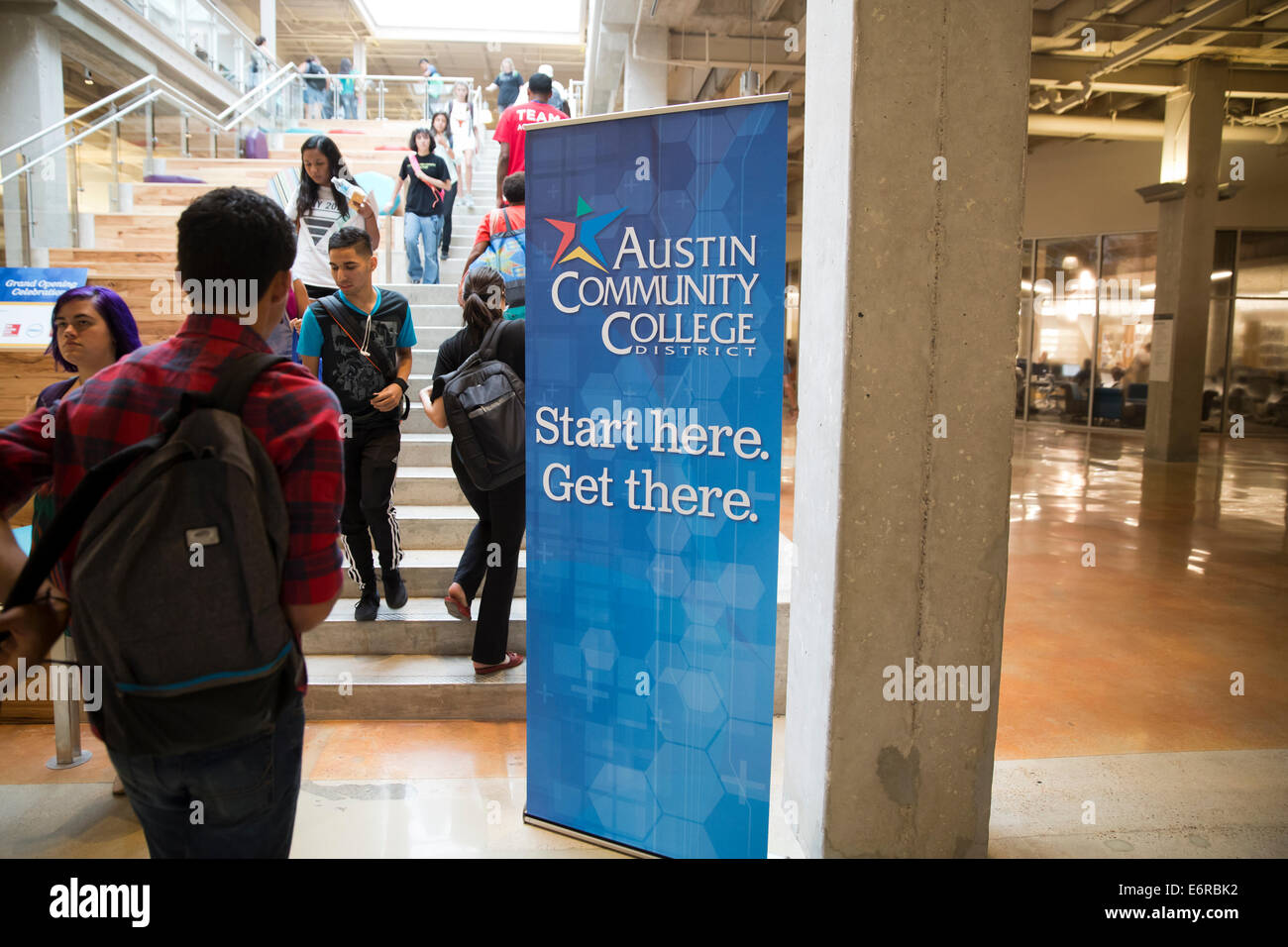 students of all ages and teachers walk up and down stairs during change ...