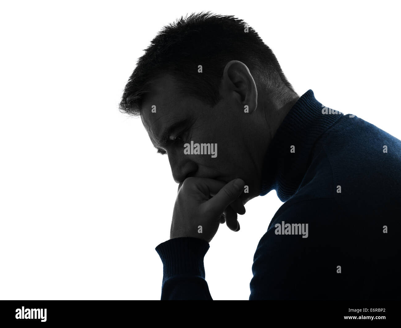 one man serious thinking pensive portrait in silhouette studio isolated ...
