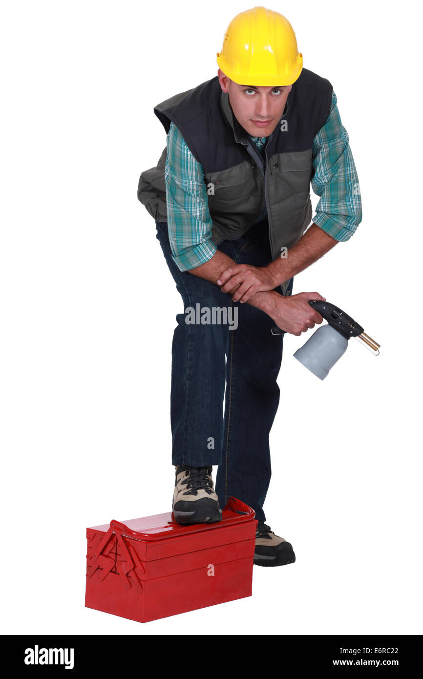 plumber with leg resting on toolbox Stock Photo - Alamy