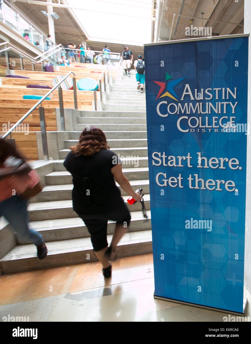 students of all ages and teachers walk up and down stairs during change ...