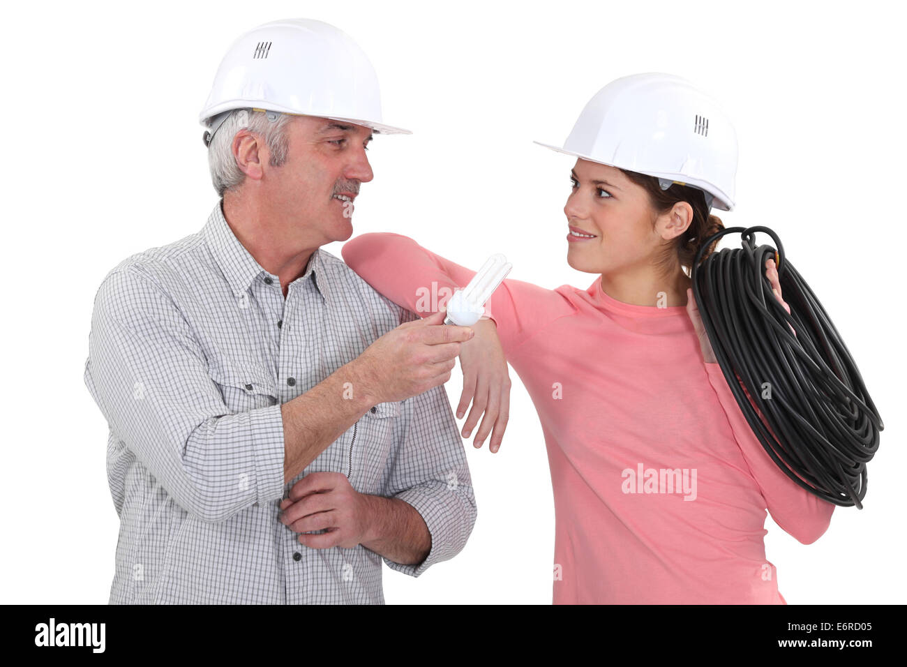 electricians talking and holding a bulb and a wire Stock Photo - Alamy