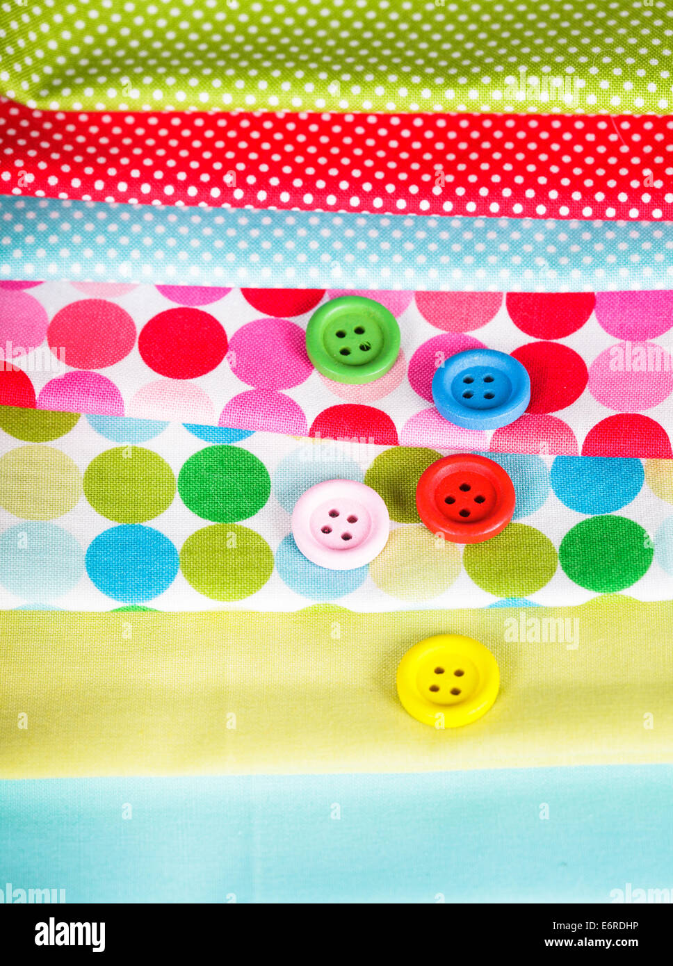 Colorful wooden buttons on the textiles, sew concept Stock Photo - Alamy