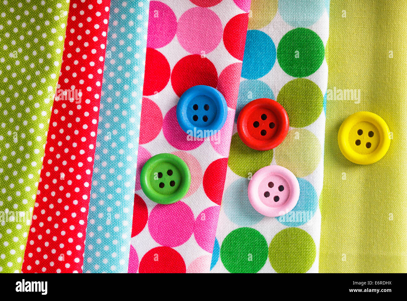 Colorful wooden buttons on the textiles, sew concept Stock Photo - Alamy