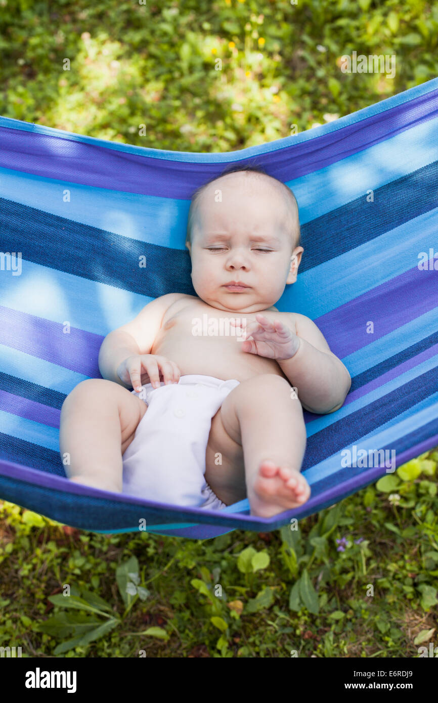 Baby in a hammock nave a daytime naps outdoors Stock Photo - Alamy