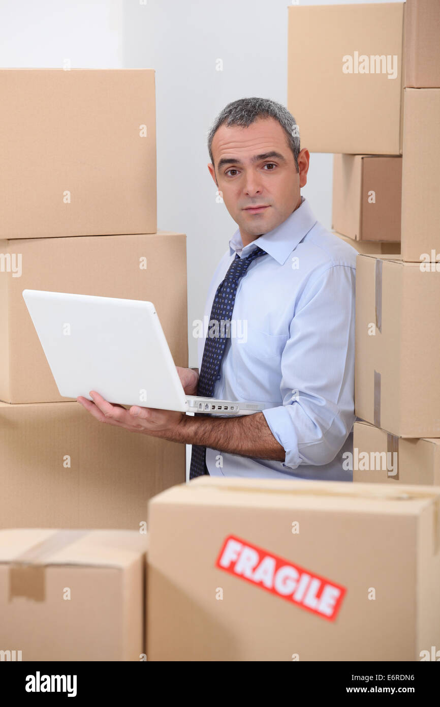 Man moving boxes Stock Photo - Alamy