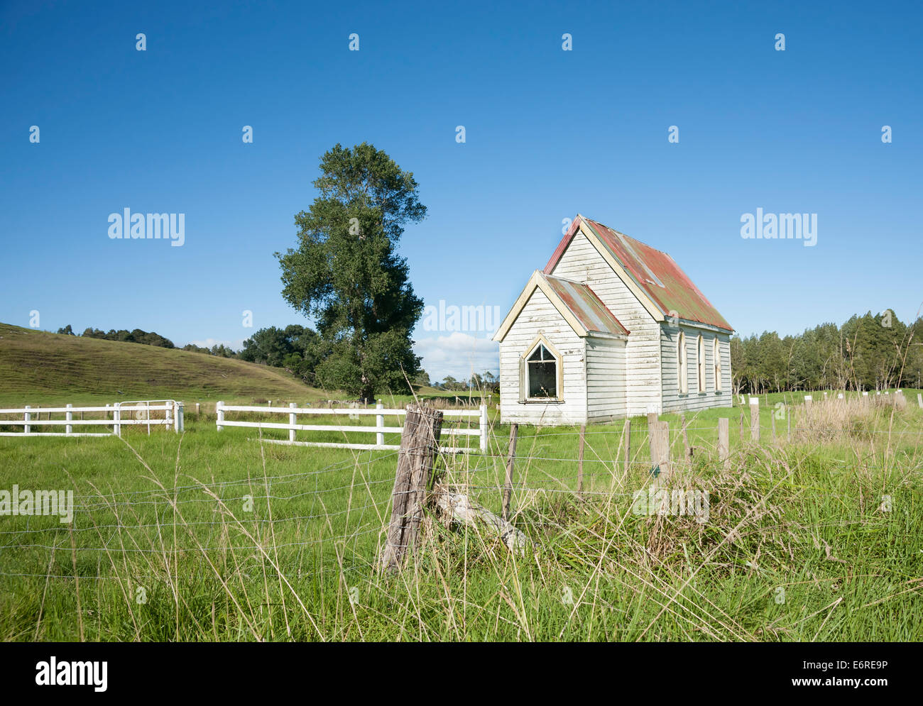 Small white church in meadows with little white fence Stock Photo - Alamy