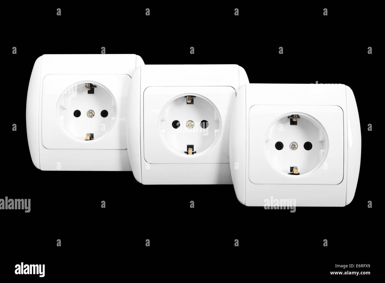 The white electric socket with grounding on a black background. It is ...
