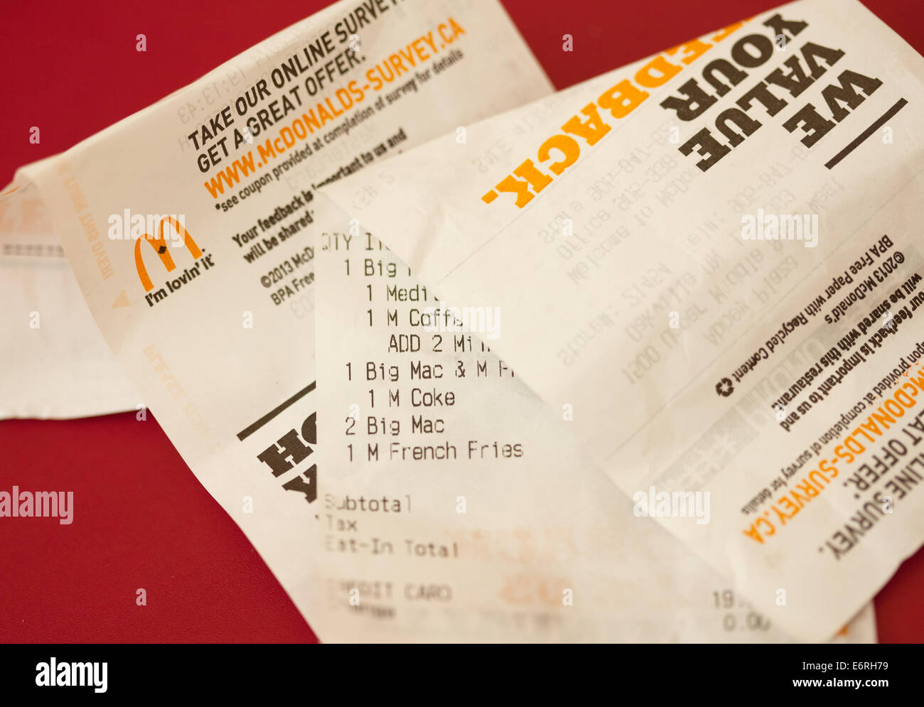 Meal bill from Macdonald's on a red background focus on food items ...