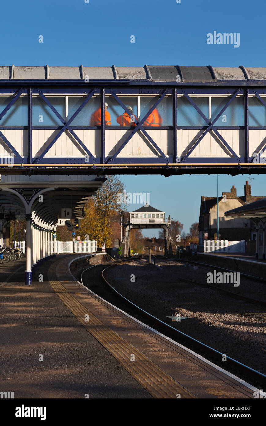 In Selby railway station, there men in orange were on the bridge Stock ...