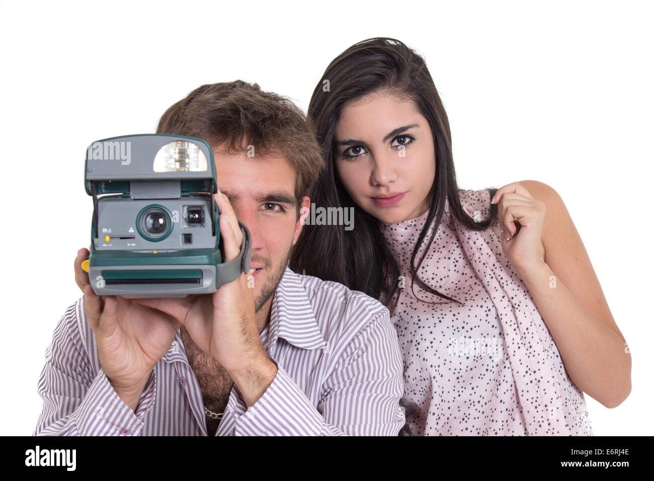 Closeup of beautiful girl and attractive man using an instant camera ...
