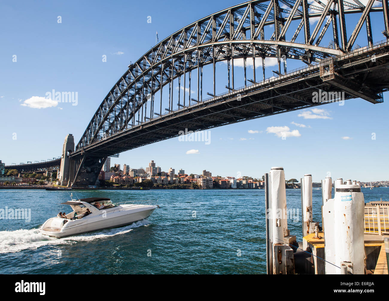 A motor yacht passes underneath the Harbour Bridge in Sydney Stock ...
