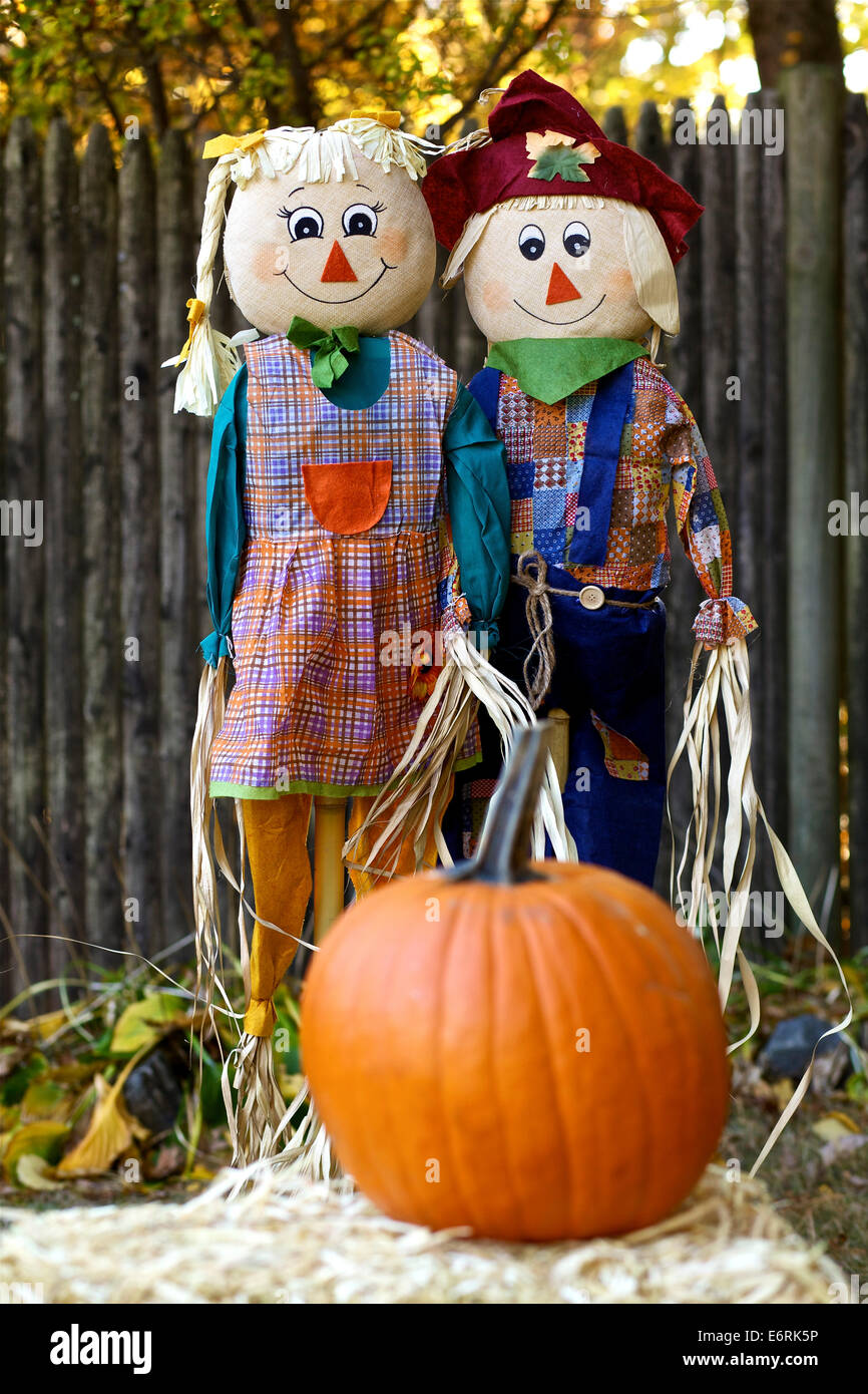 Two happy scarecrows and pumpkin in a garden Stock Photo - Alamy