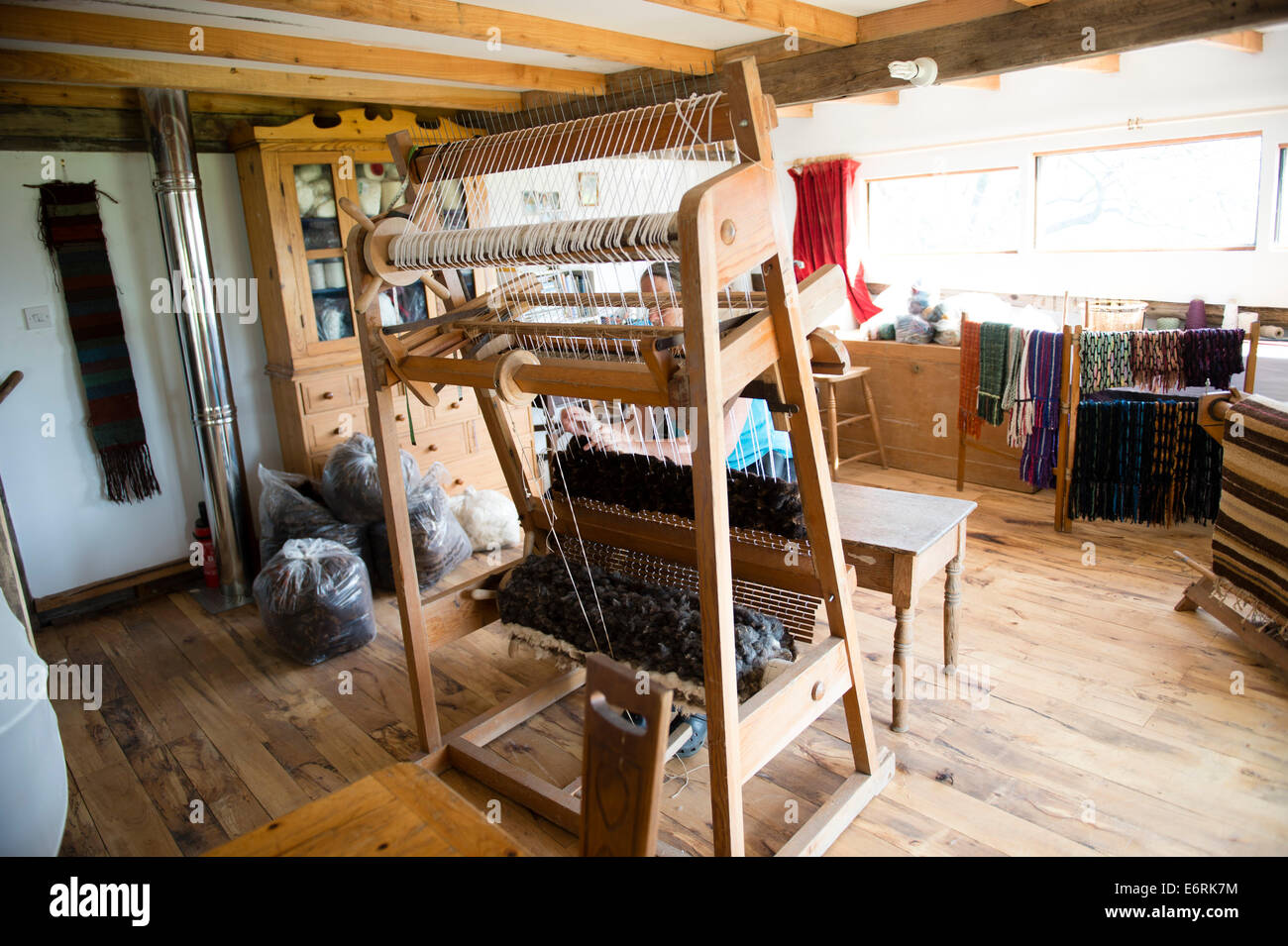 BERYL SMITH, weaver and basket maker, working weaving wool on a loom in ...