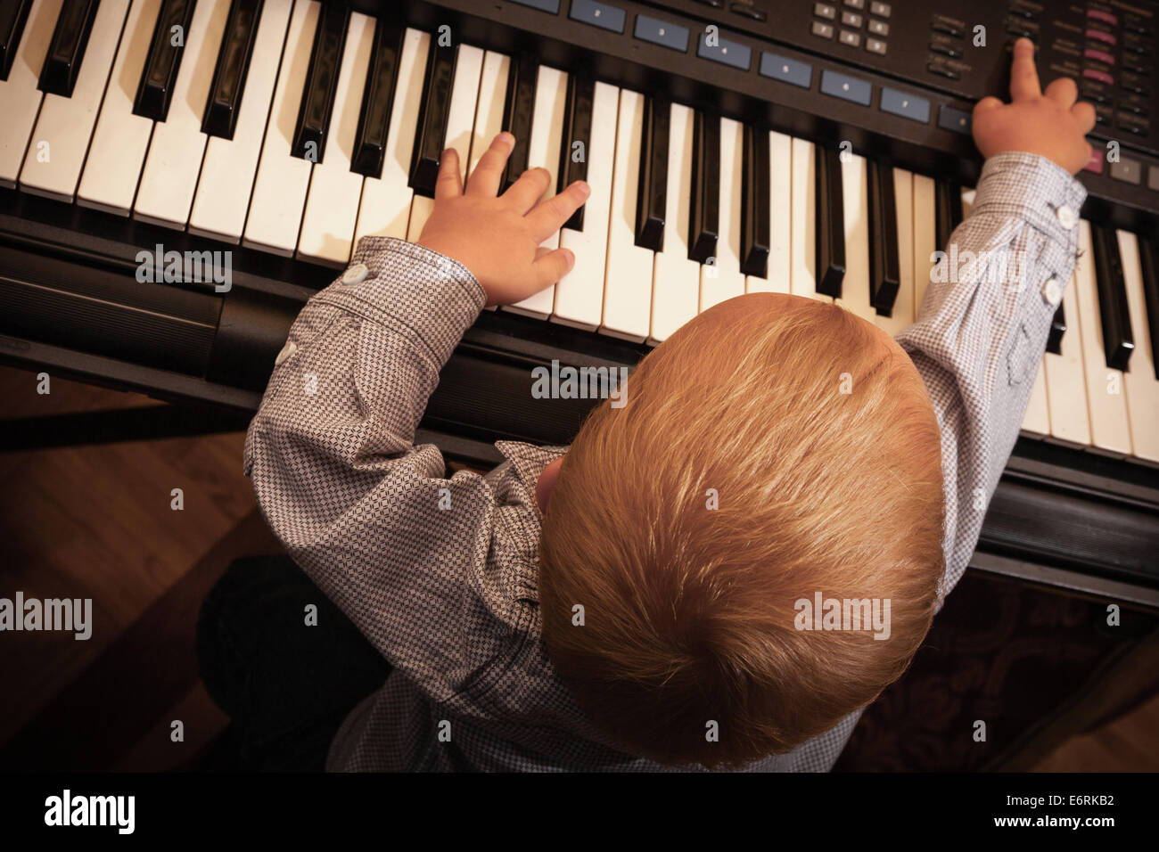 Boy child kid playing on digital keyboard piano synthesizer Stock Photo ...