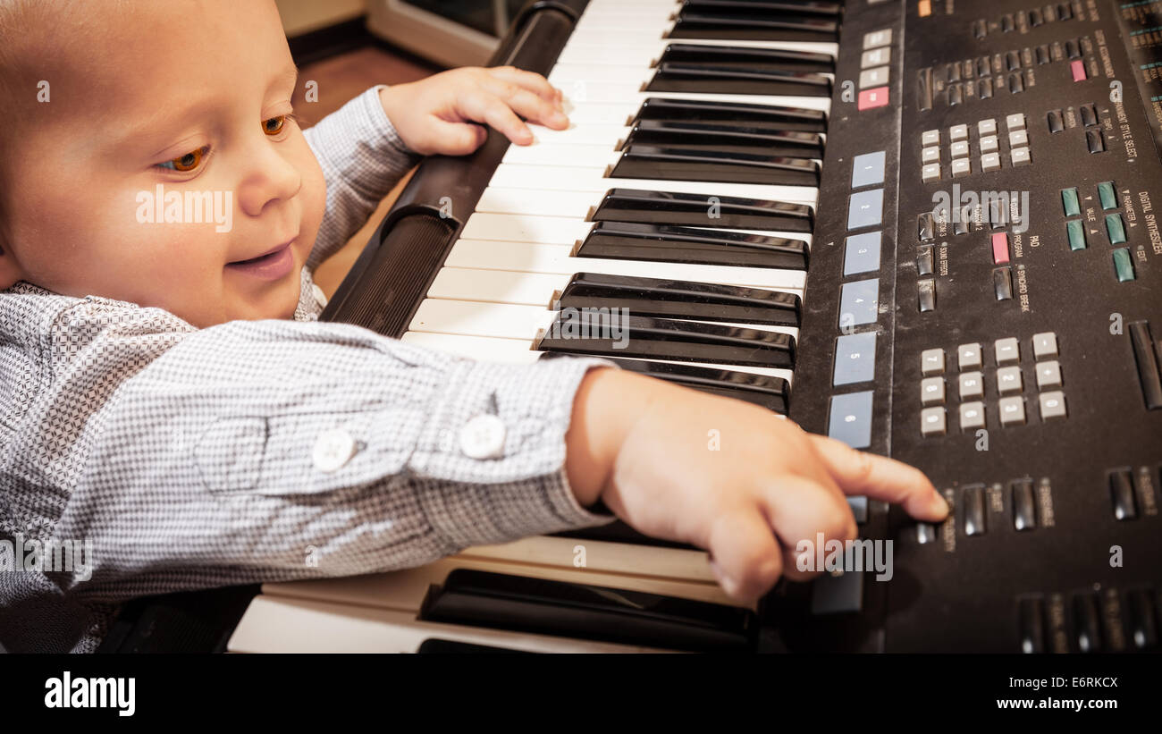 Boy child kid playing on digital keyboard piano synthesizer Stock Photo ...