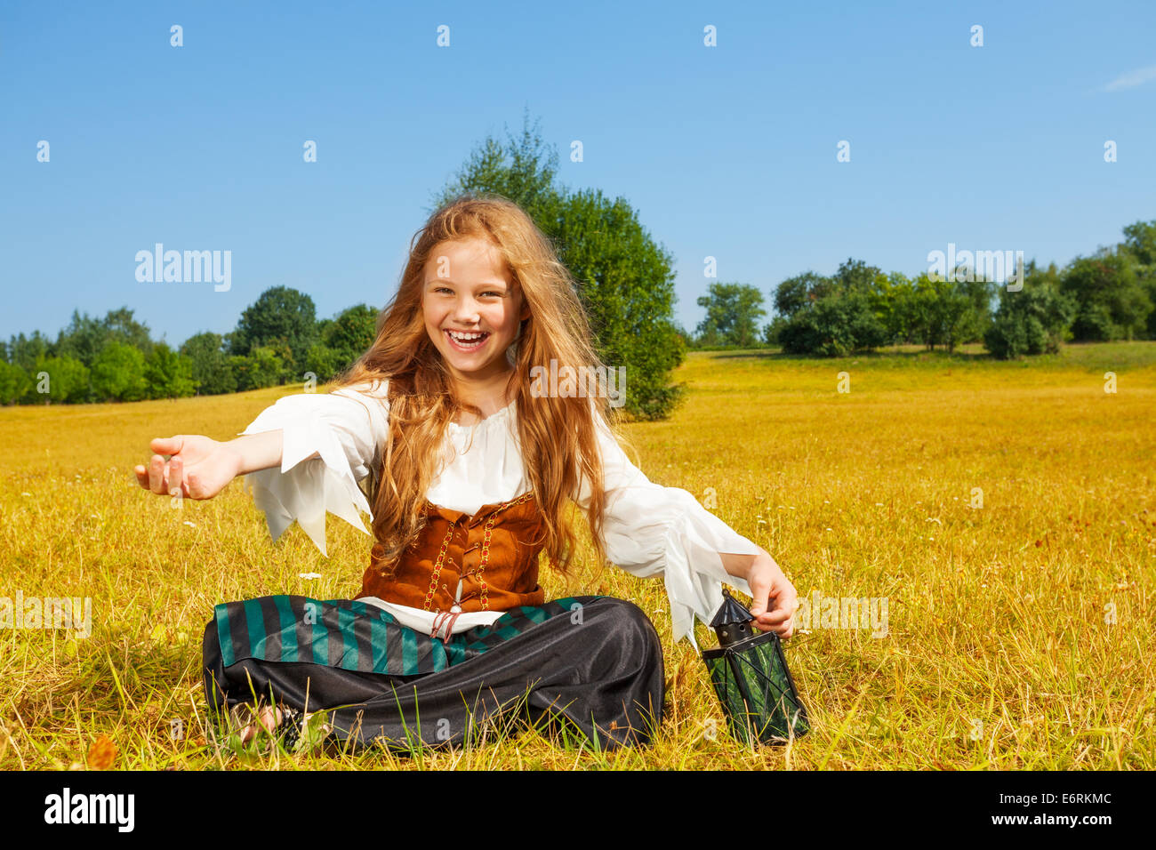 Laughing girl in costume of pirate sitting Stock Photo - Alamy