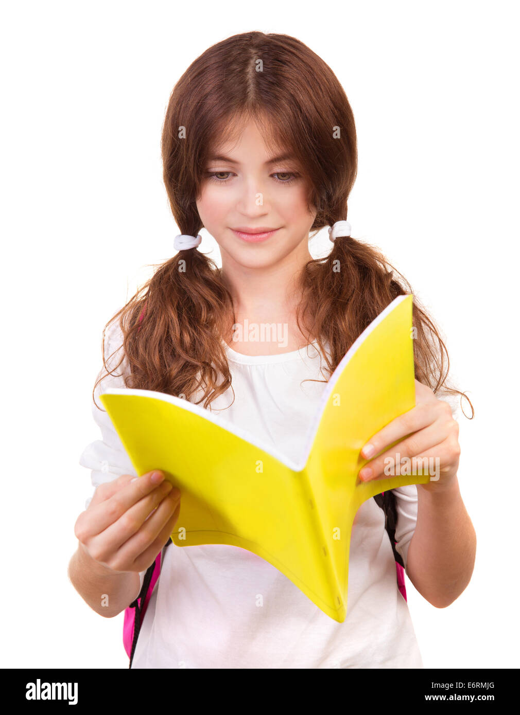 Portrait of cute teen girl reading book isolated on white background ...